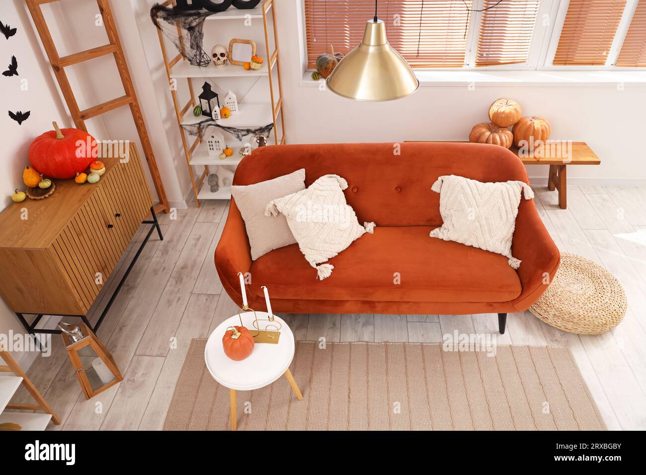 Interior of living room decorated for Halloween with red sofa and table ...