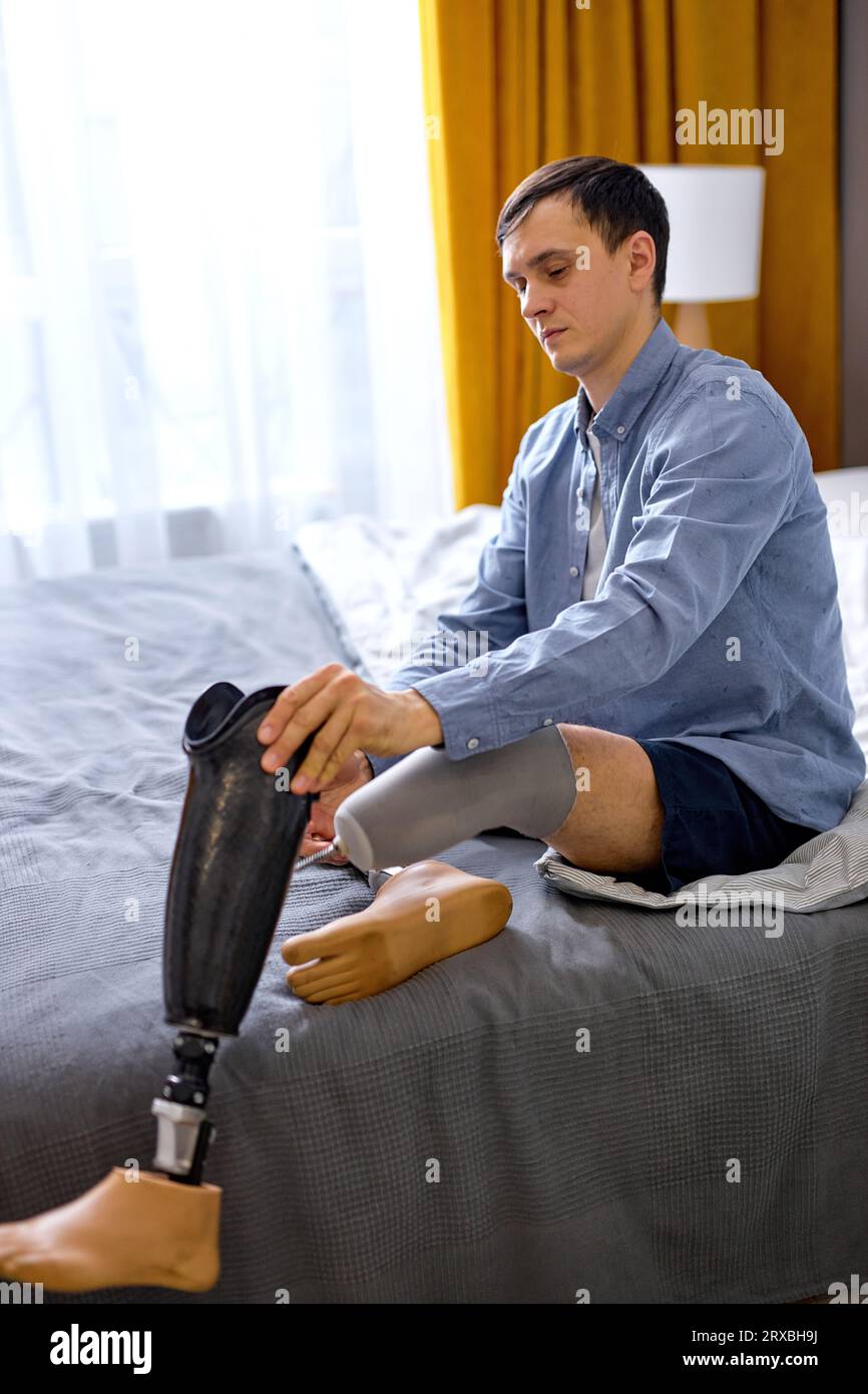 handsome disabled man wearing prosthesis on leg in the morning ...