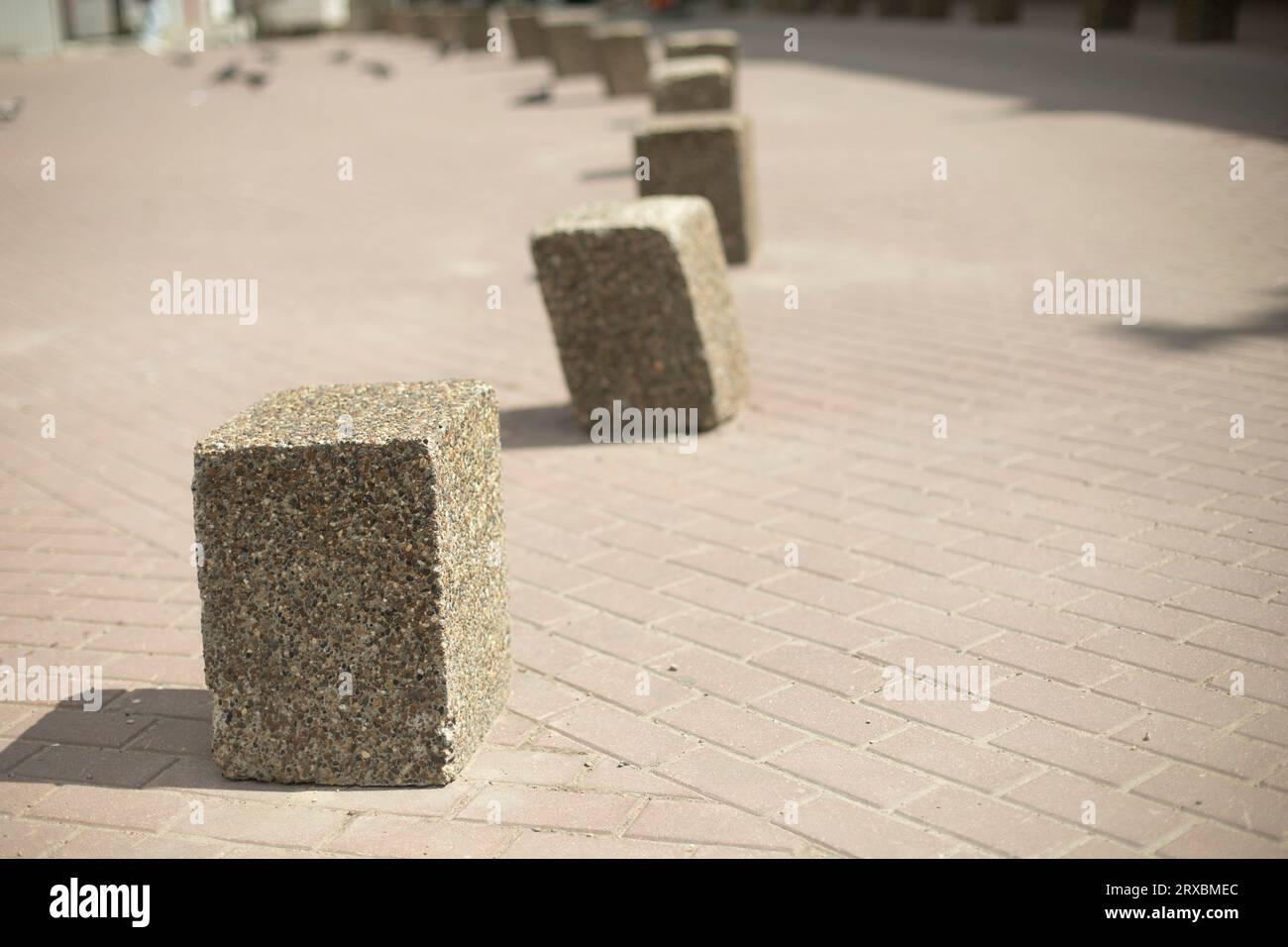 Parking poles. Fence from cars on pavement. Stone obstacles in city ...