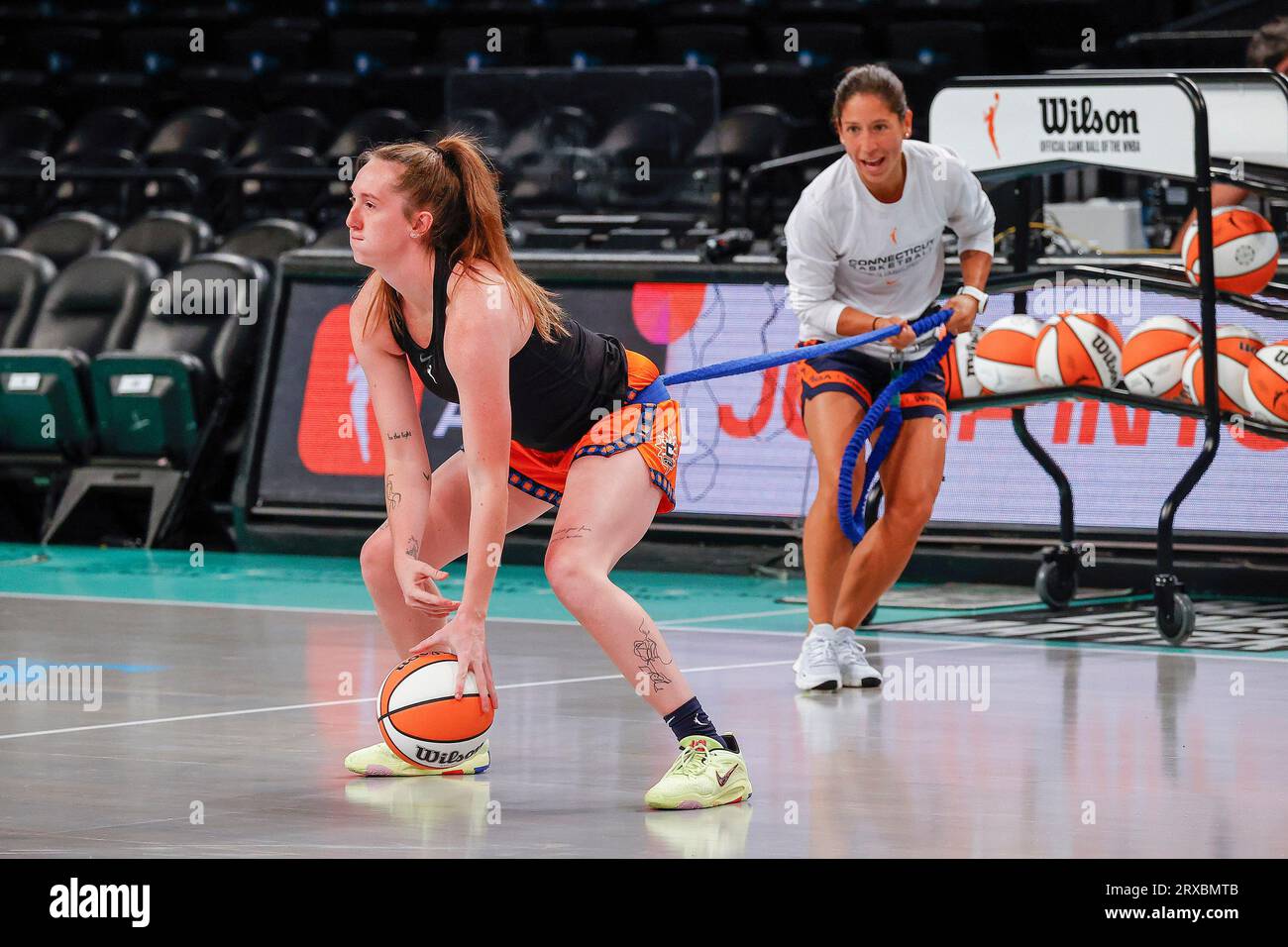 Connecticut Sun guard Leigha Brown, left, warms up before a WNBA ...