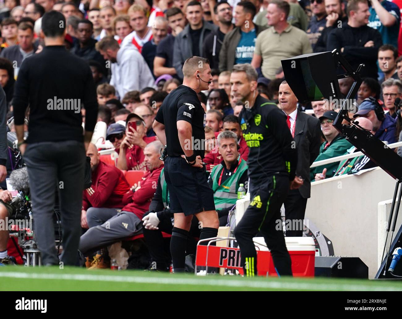 Referee Robert Jones checks the VAR pitchside screen during the Premier ...