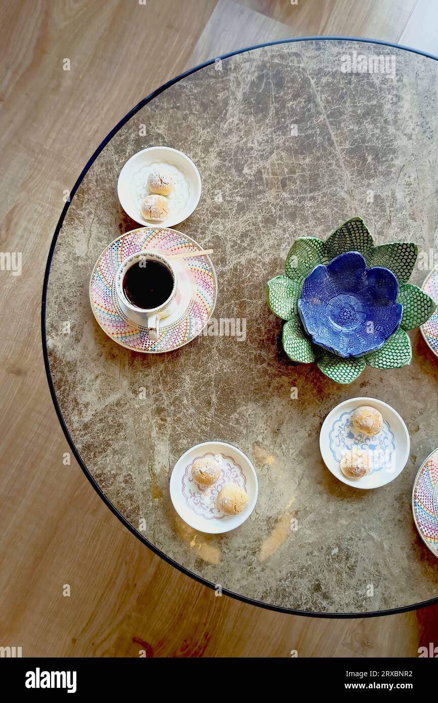 A circle table topped with dessert plates and coffee cup Stock Photo ...