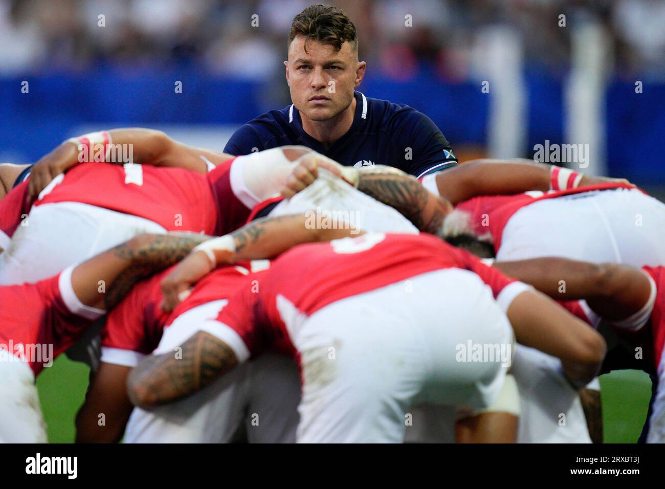 Scotland's Jack Dempsey, center, looks above as Tonga's players contest ...