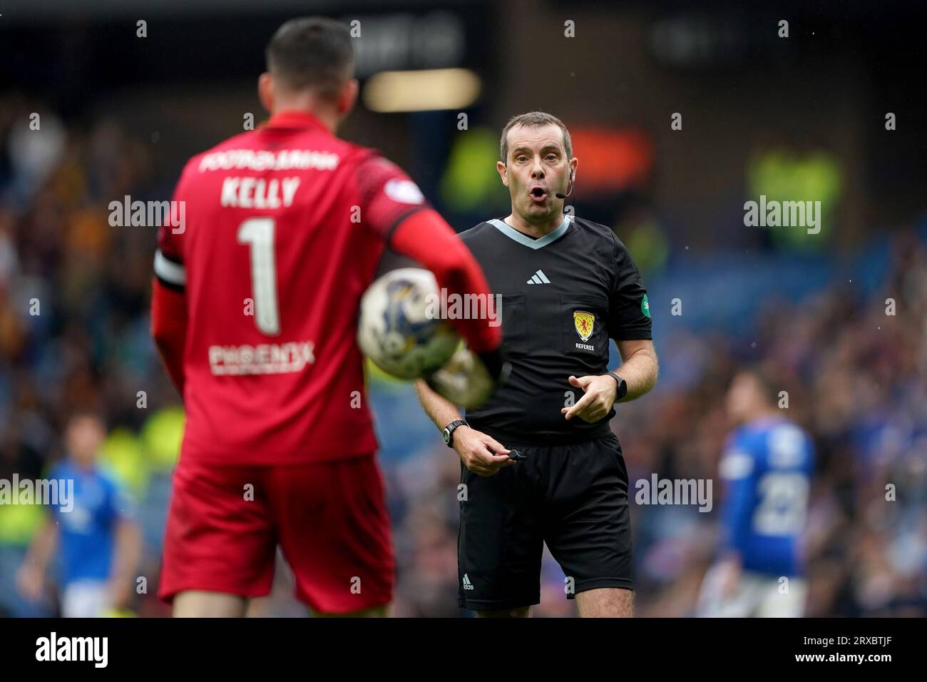Referee Alan Muir interacts with Motherwell's Liam Kelly (left) during ...