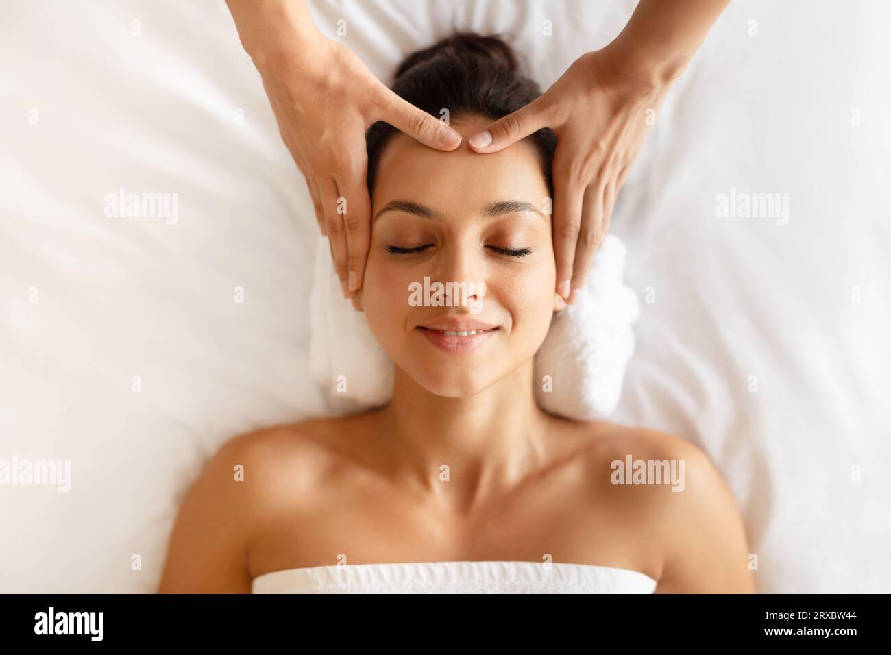 Lady Receiving Head Massage Lying On Bed Indoor, Top View Stock Photo ...
