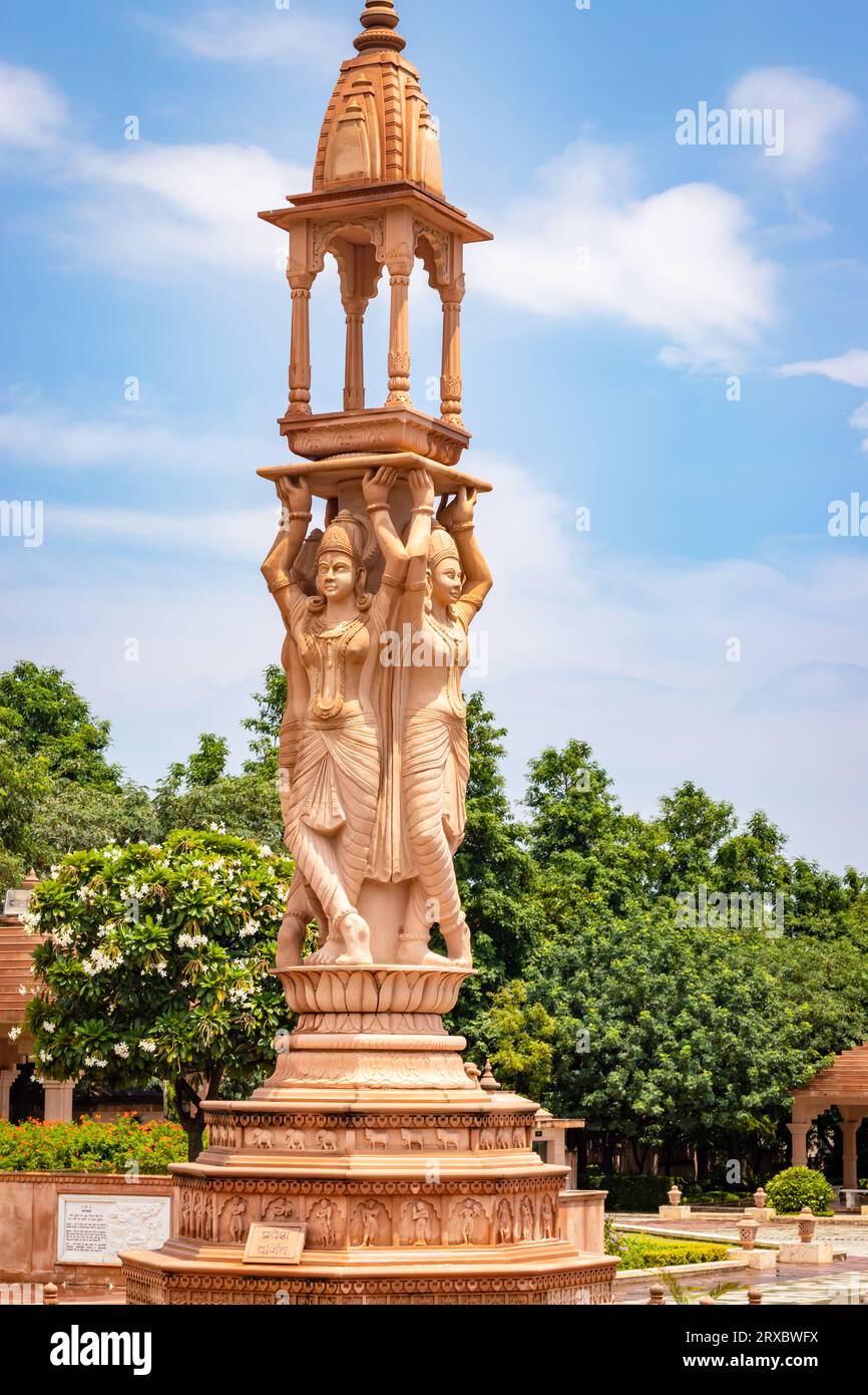 artistic red stone jain god holy pillar at morning from unique angle ...