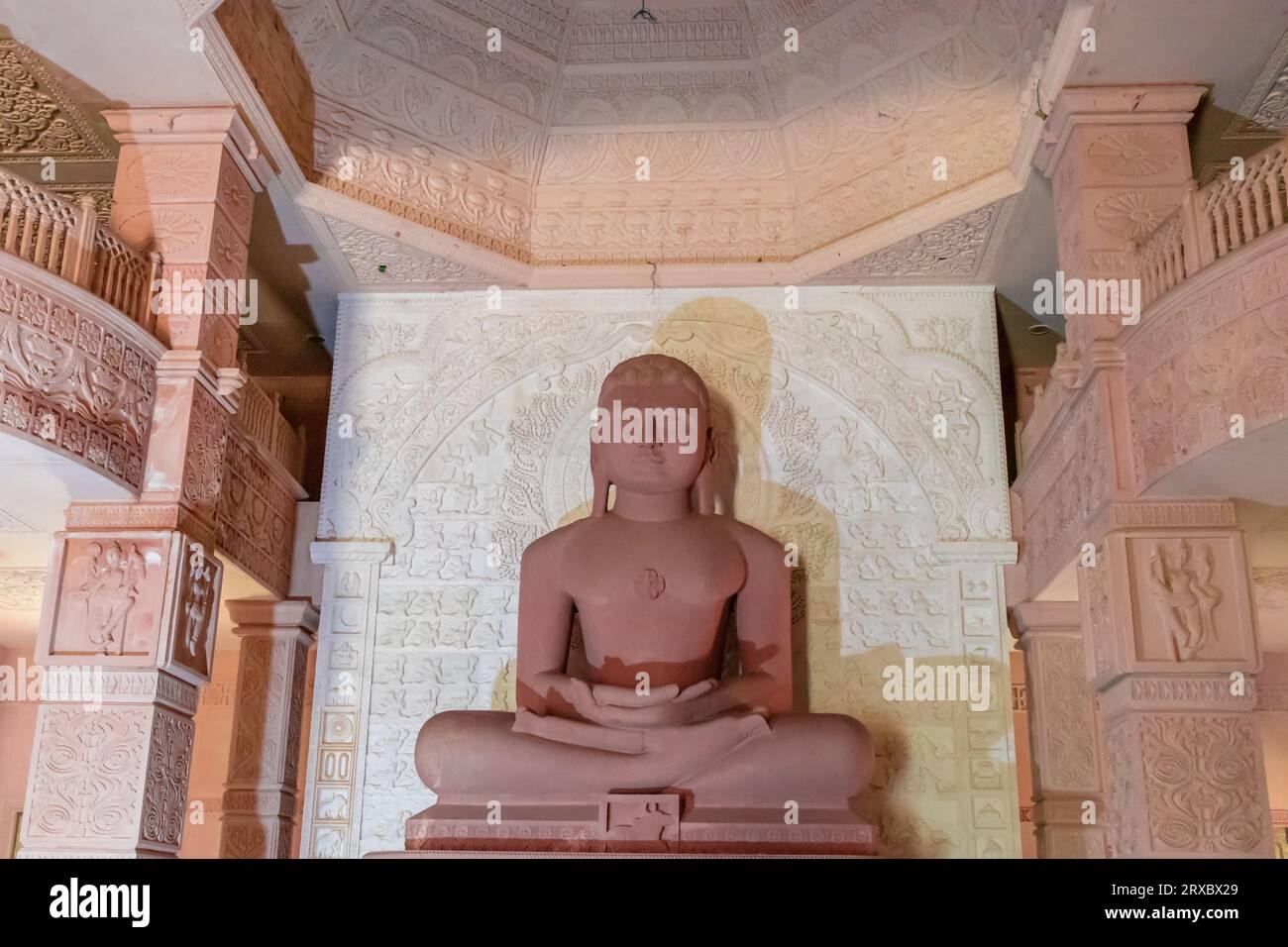 isolated red stone jain god holy statue in meditation from different ...