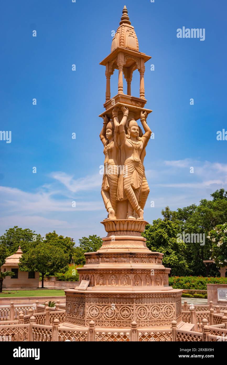 artistic red stone jain god holy pillar at morning from unique angle ...