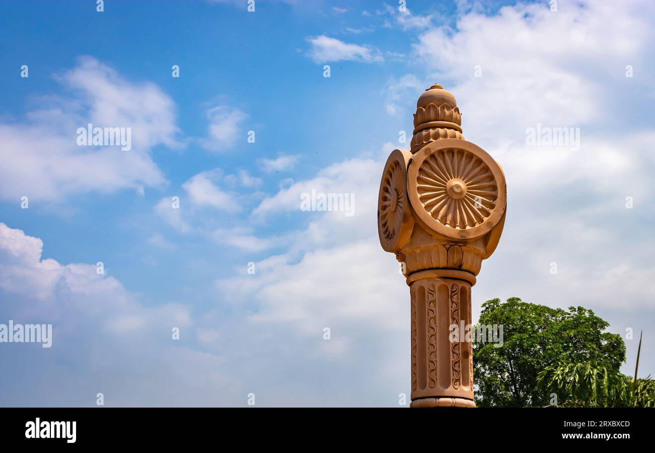 artistic red stone jain god holy pillar with bright blue sky at morning ...