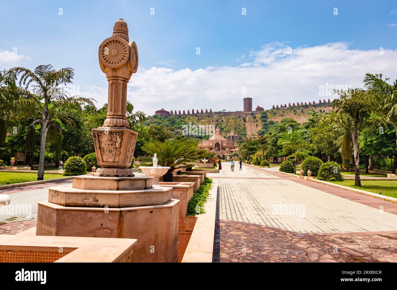 artistic red stone jain god holy pillar with bright blue sky at morning ...