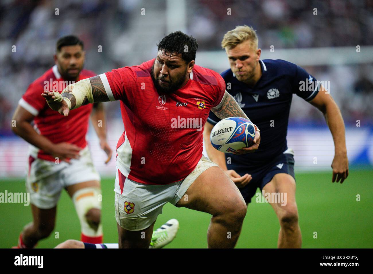 Tonga's Ben Tameifuna runs with the ball to score a try during the ...