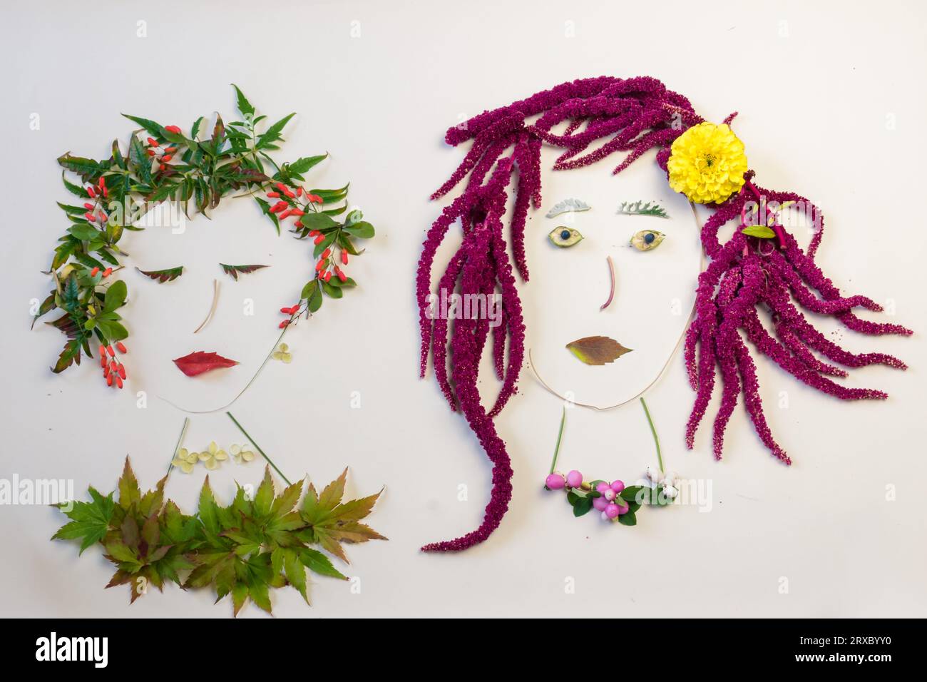 female face with hair made from red autumnal leaves and flowers ...