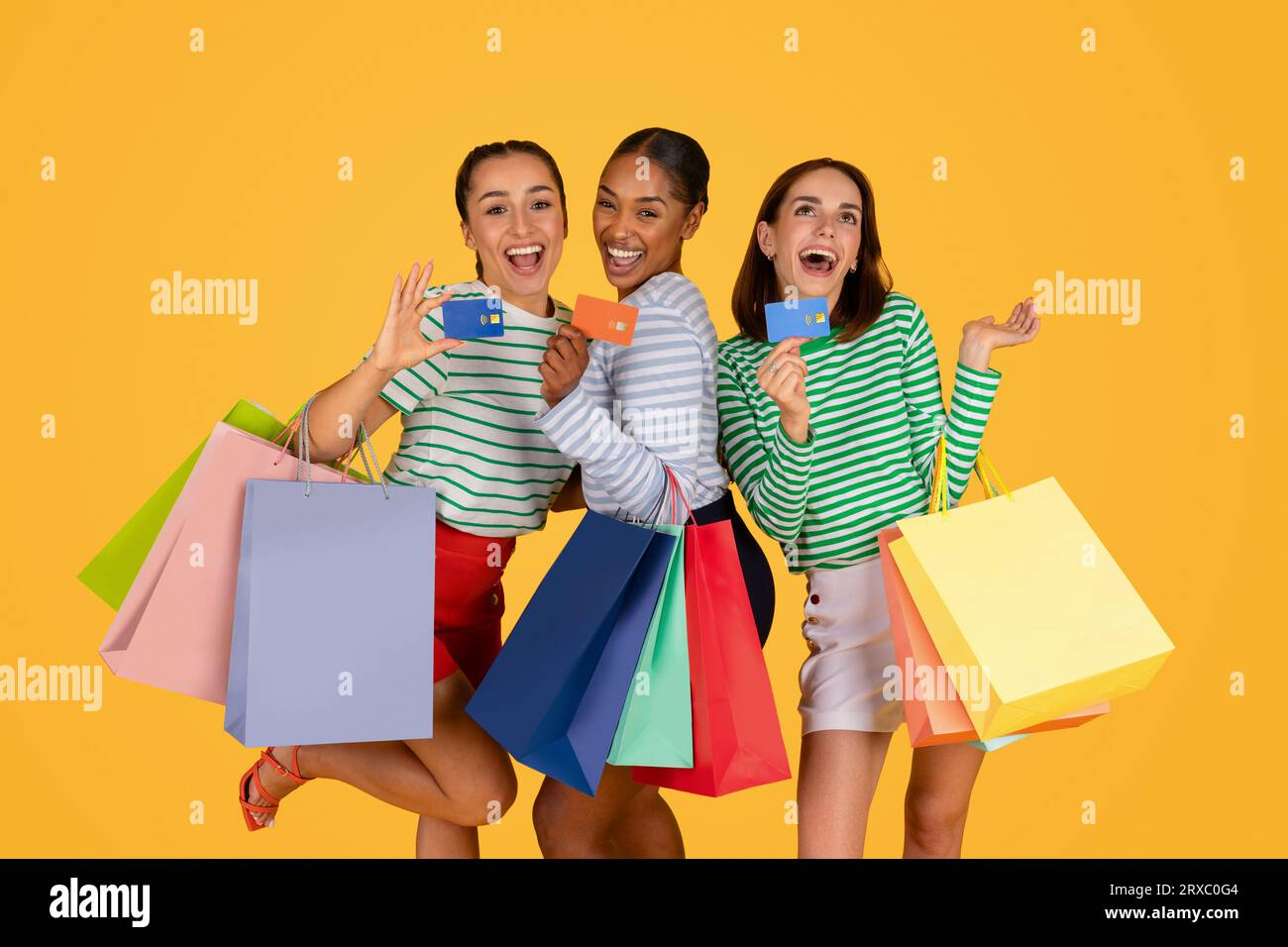 Happy millennial multiracial women with purchases and credit cards ...