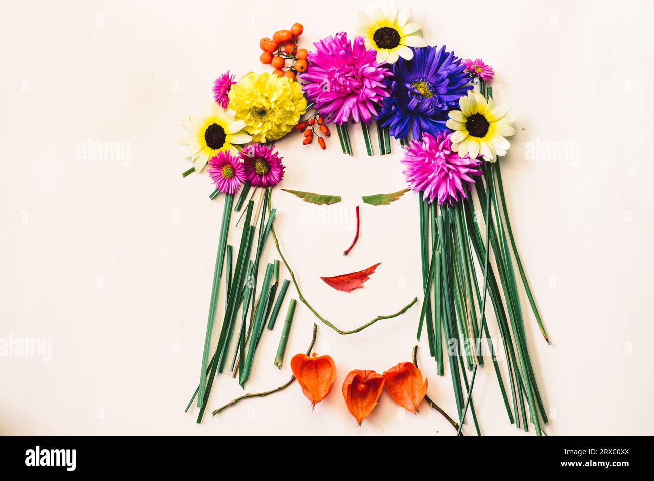 female face and hair made from colorful autumnal leaves and flowers ...