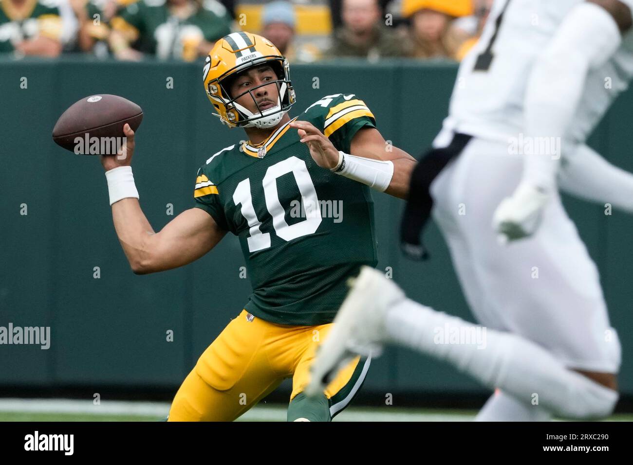 Green Bay Packers quarterback Jordan Love (10) slips as he throws on ...