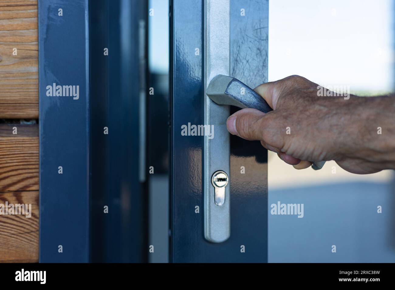 male hand of an elderly person opens the door. hand opens the door by ...