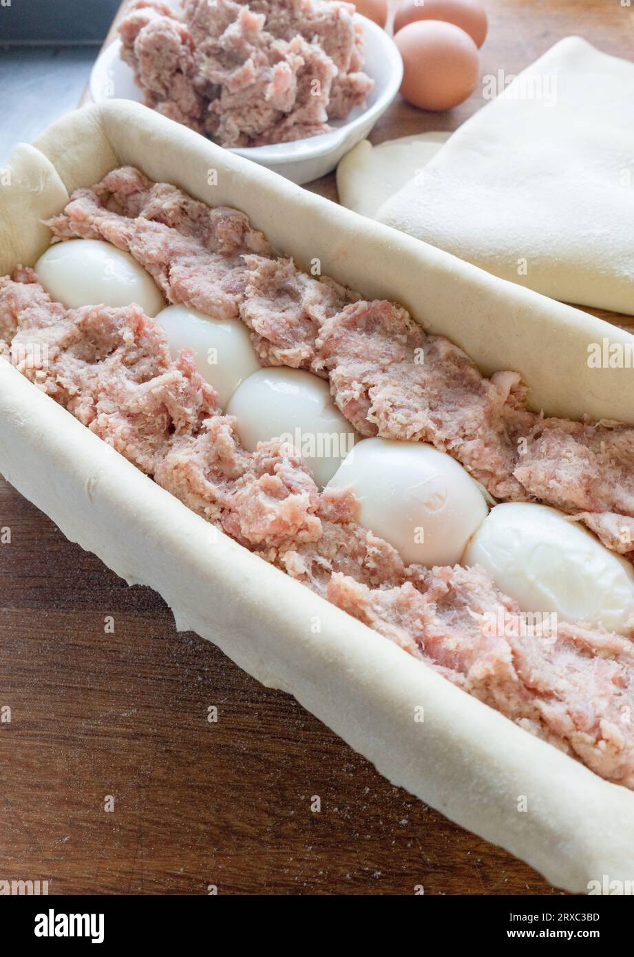Before being baked, a Gala Pie rests on a wooden block.Ready to crump ...