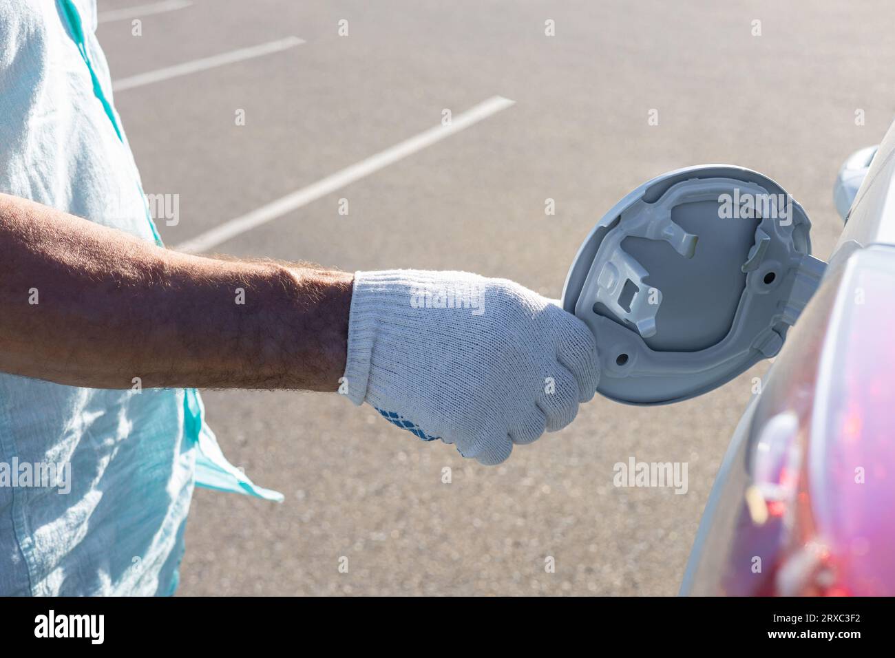 the driver opens the hatch of the gas tank. hand opens gas tank Stock ...
