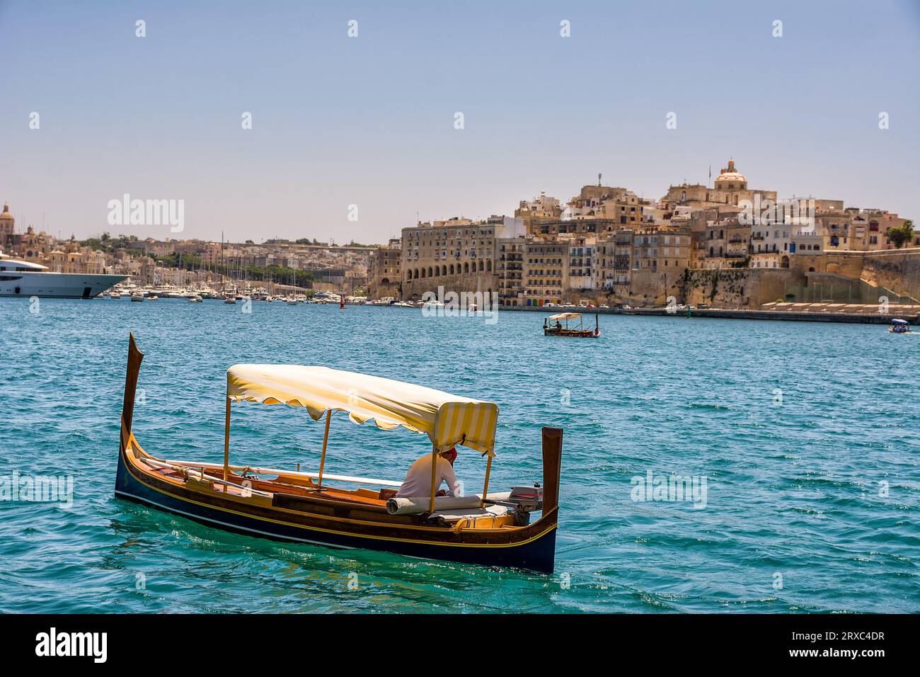 Luzzu, a typical Maltese boat and in the background Vittoriosa in Malta ...