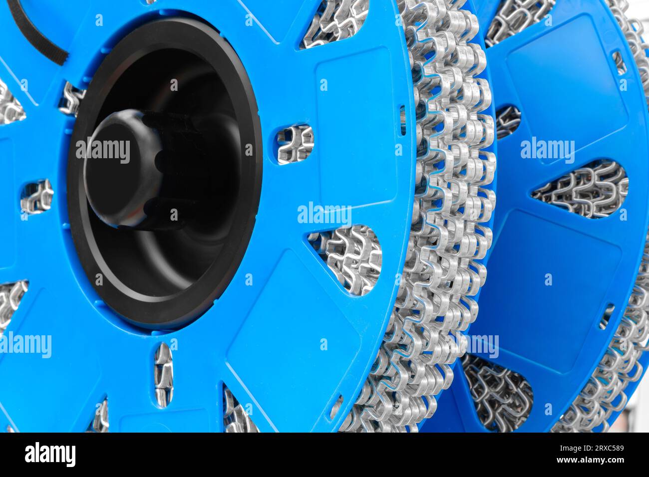 Strand roller chain going around sprockets on industrial machine ...
