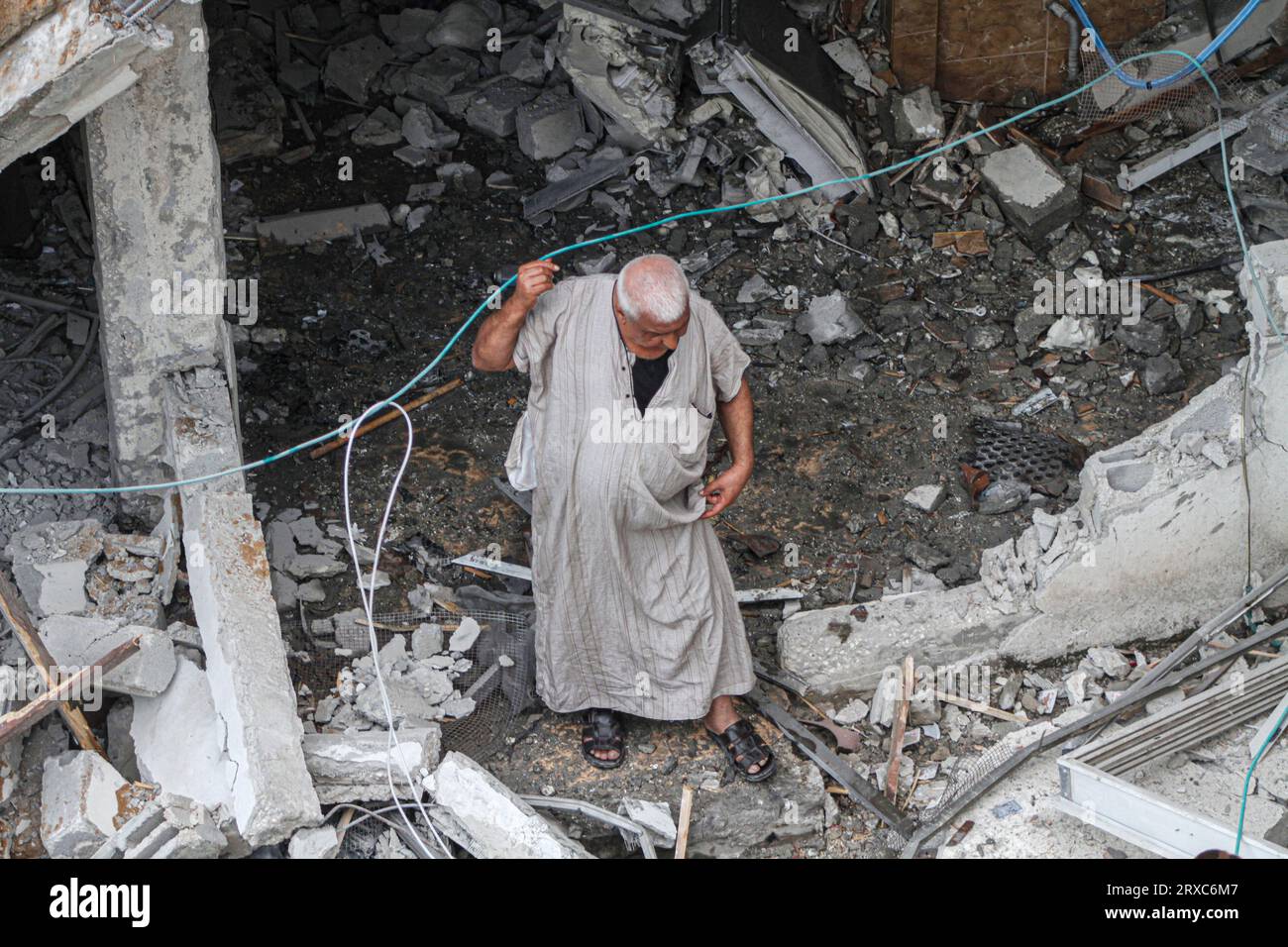 A Palestinian inspects the damaged building caused by the Israeli army ...