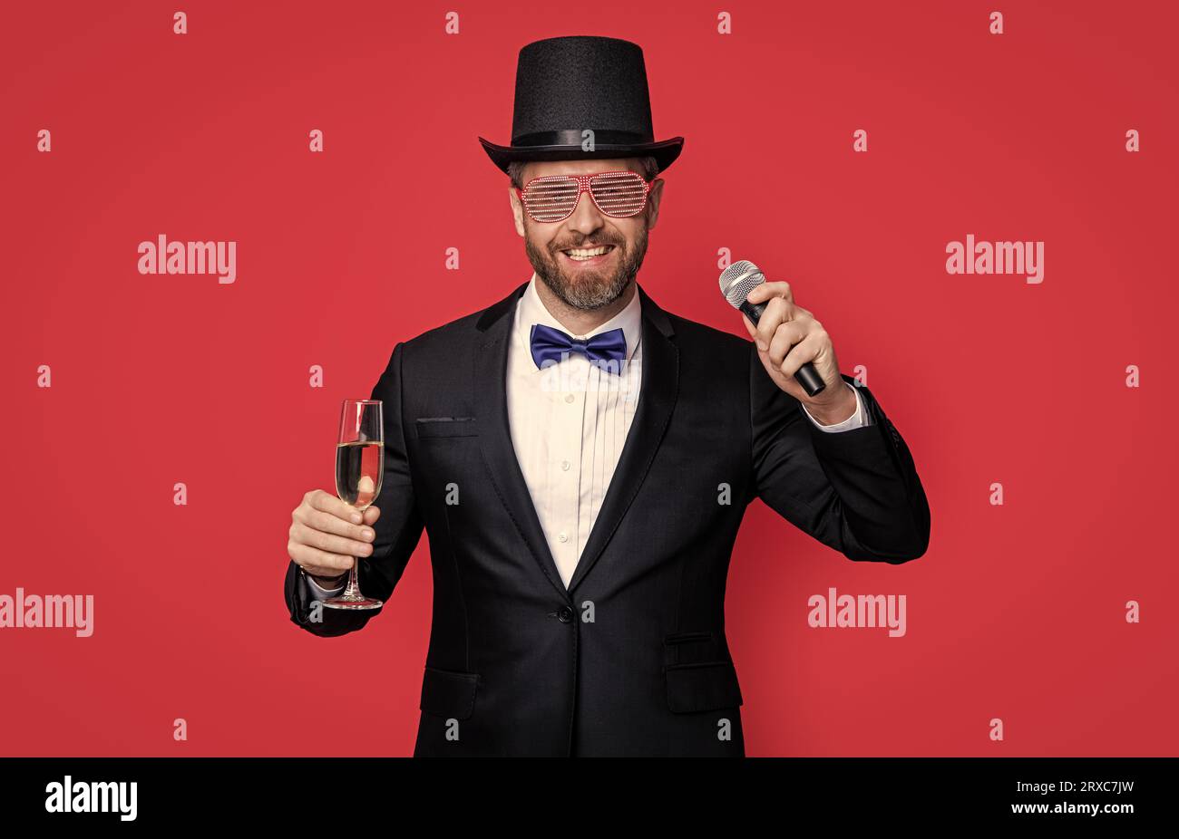 magician man cheering with microphone. man magician wear tuxedo in ...