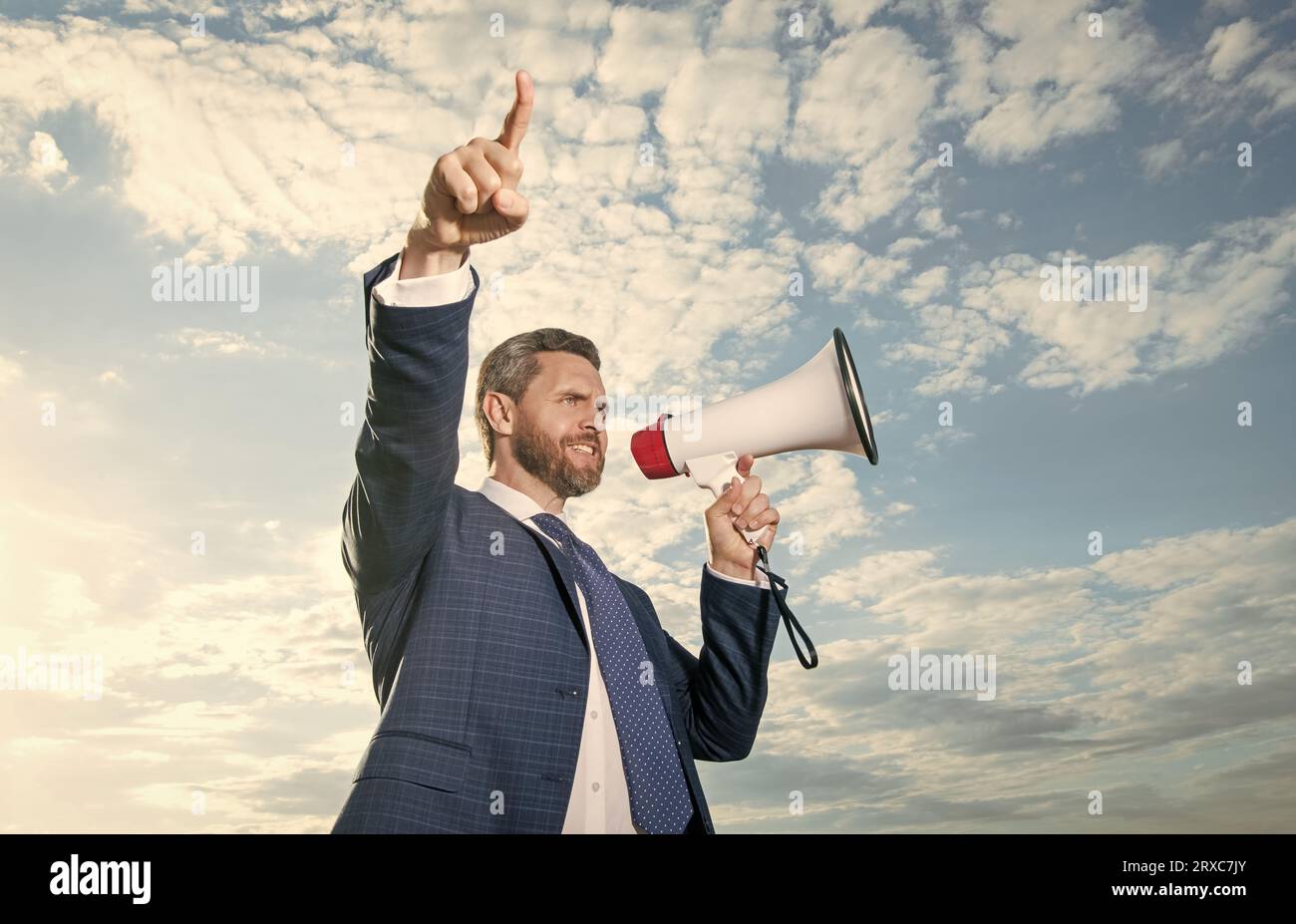 businessman shout in loudspeaker on sky background. point finger Stock ...