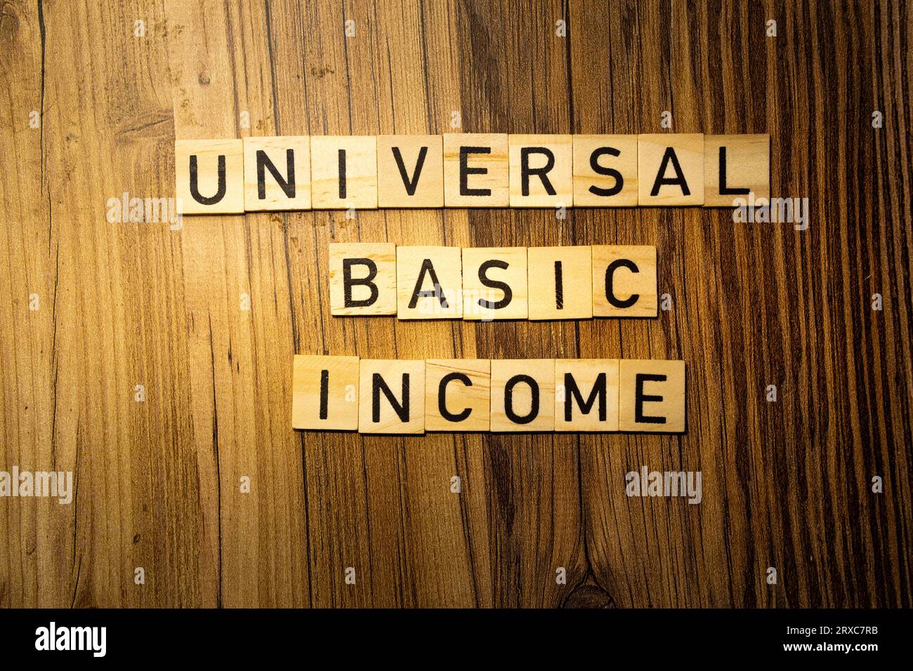 Universal Basic Income concept word in wooden letters on dark wood ...