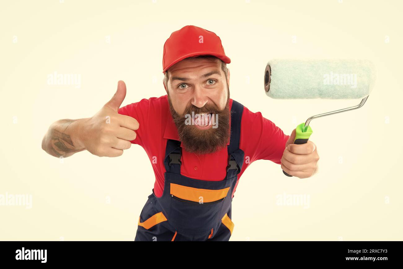happy bearded man painter with paintroller in studio. man painter with ...
