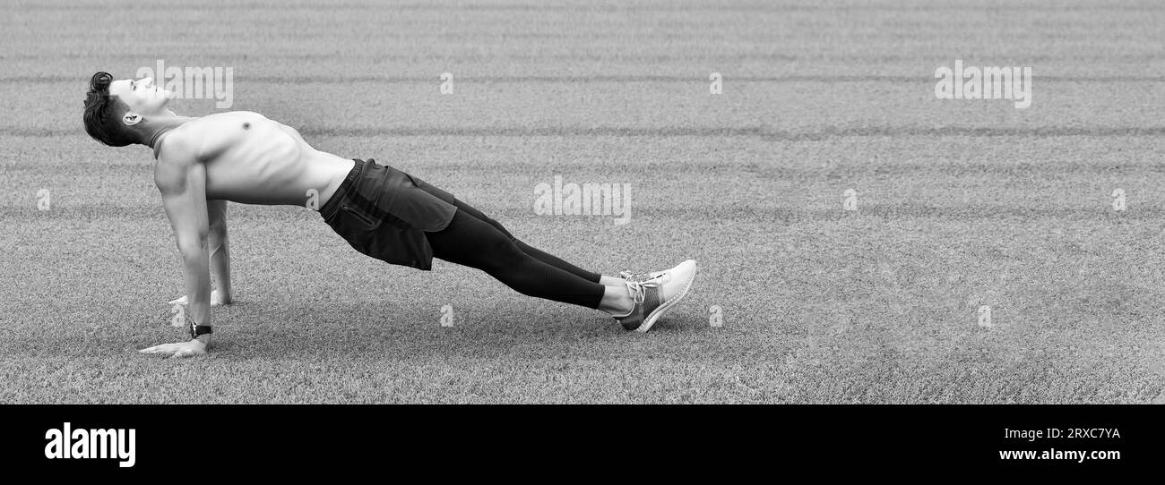 sport man on green grass, copy space. sport reverse plank exercise ...