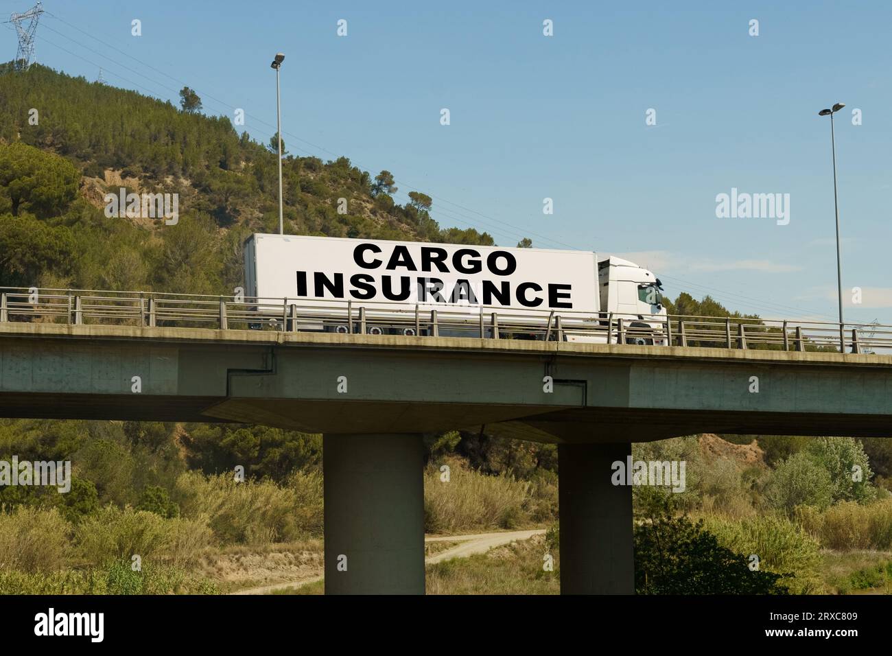 A truck is driving across the bridge, with the inscription on the ...