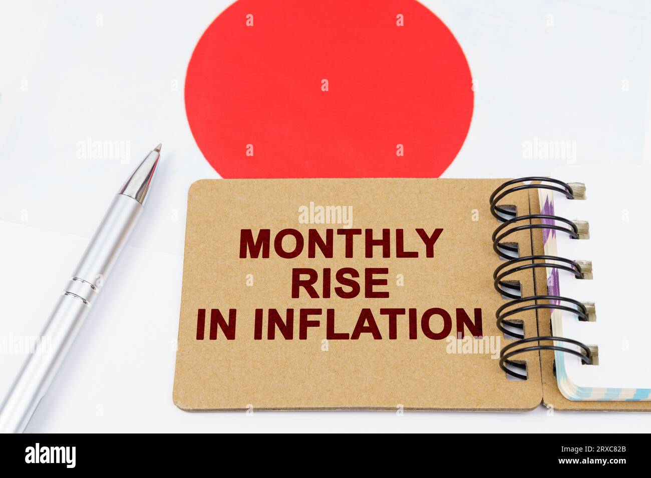 Economy and finance concept. On the flag of Japan lies a pen and a ...