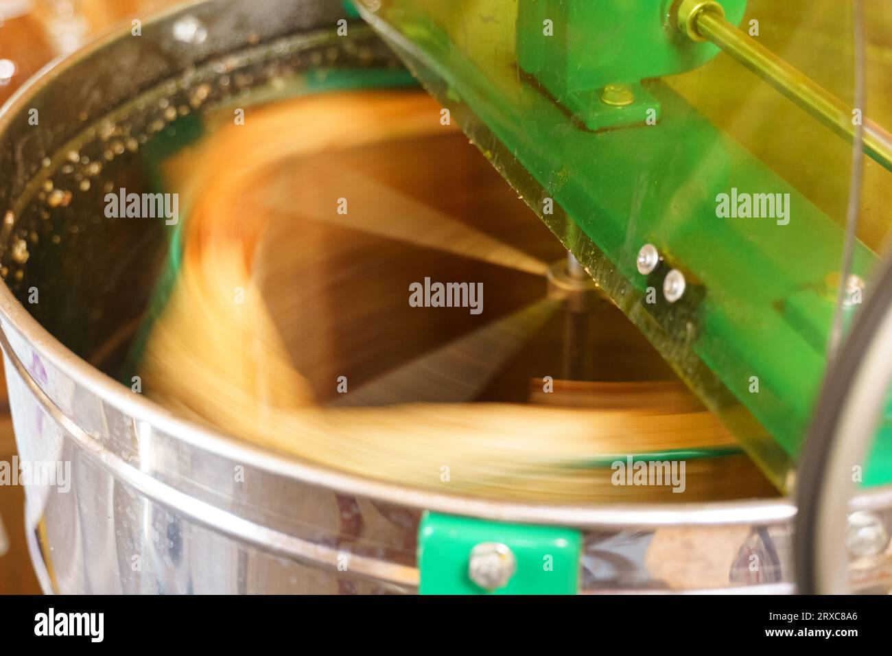 Extraction of honey from honeycombs of nesting frames in a honey ...
