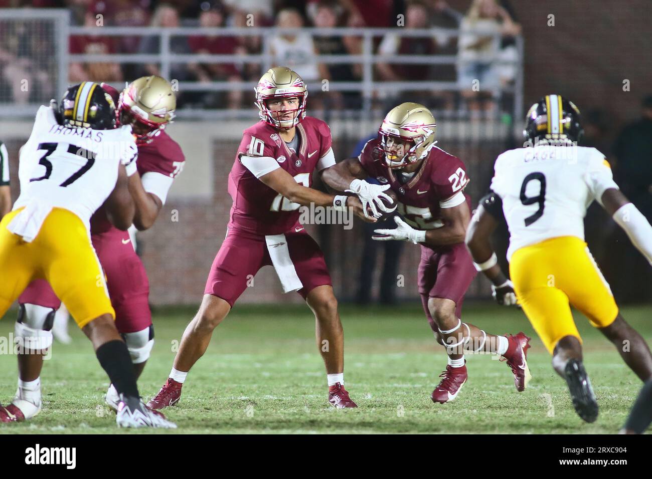 Florida State quarterback AJ Duffy (10) hands off the ball to running ...