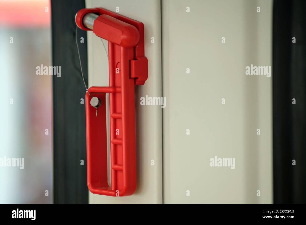 Hammer window glass breaker on the train, tram, bus and car. Red safety ...