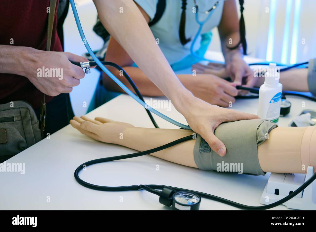 Doctor measuring blood pressure of a training dummy in hospital ...