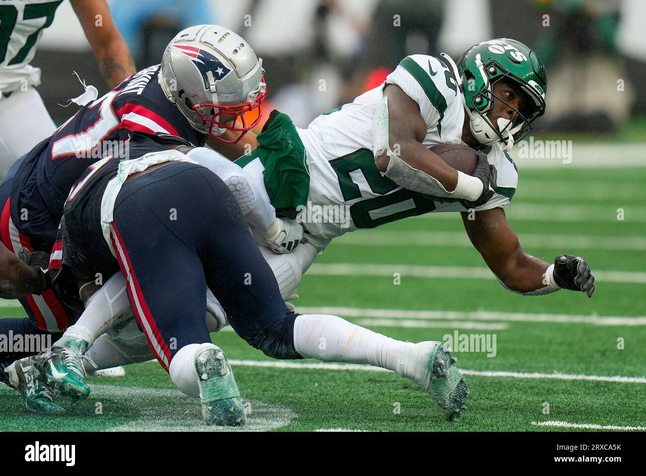 New York Jets running back Breece Hall (20) is tackled by the New ...
