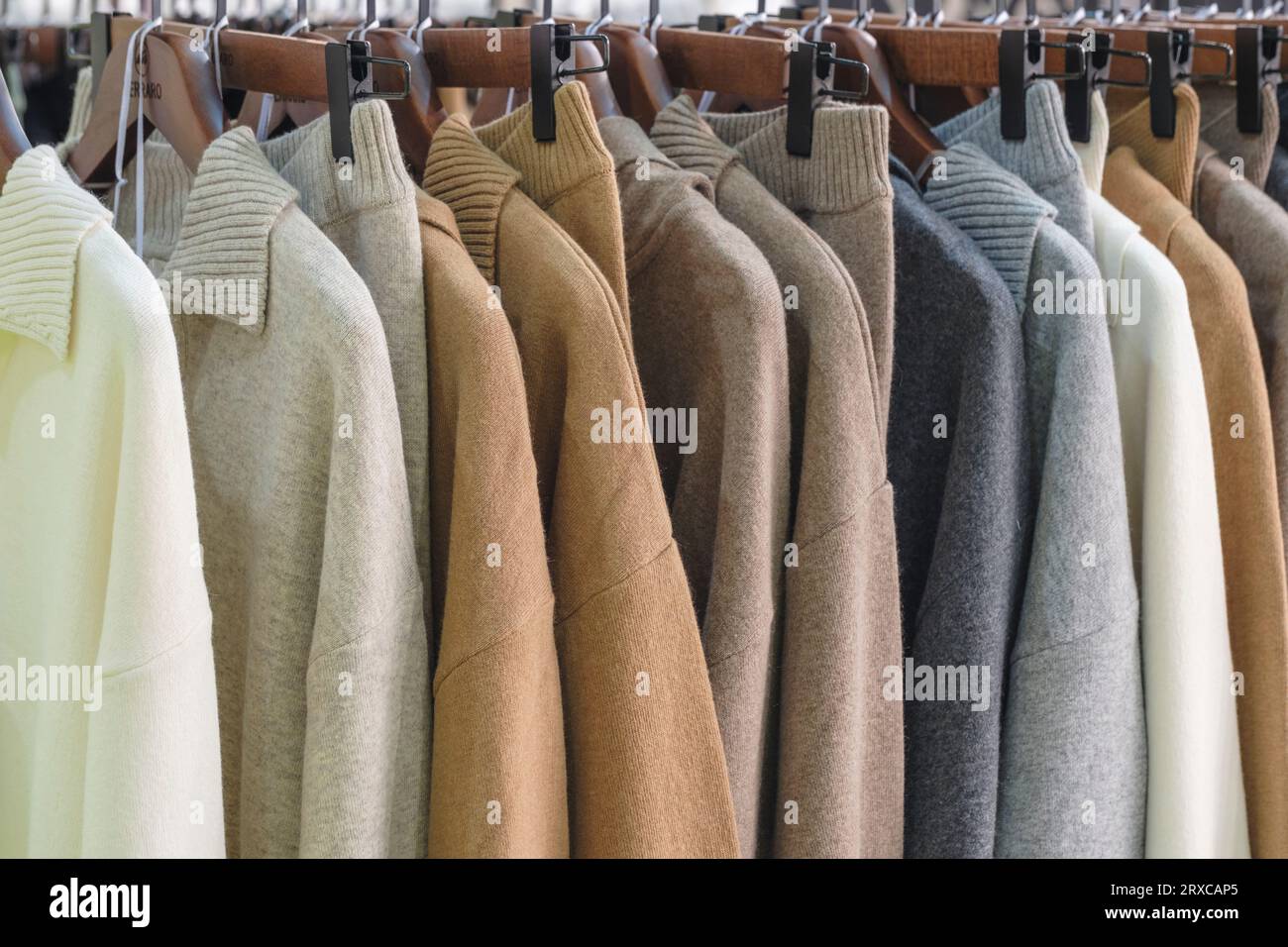 sweaters, selective focused closeup row of men's sweaters on hangers in ...