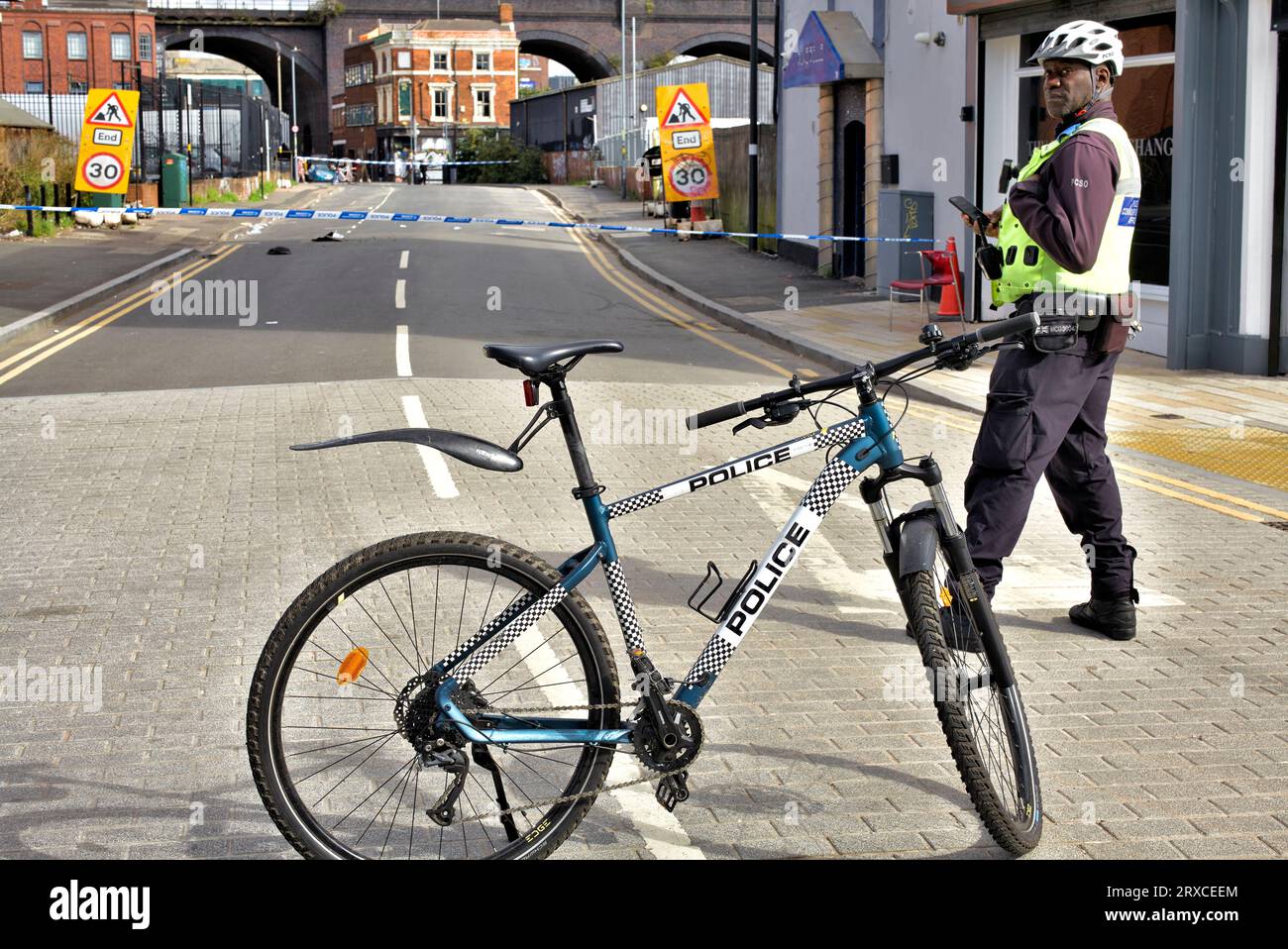 Policeman and bicycle at a cordoned off incident area, Birmingham ...