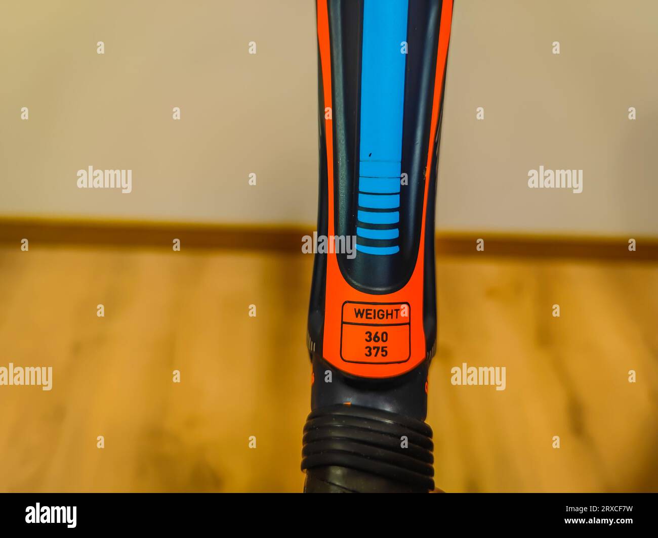 Side of padel racket with weight of the racket written in the box ...