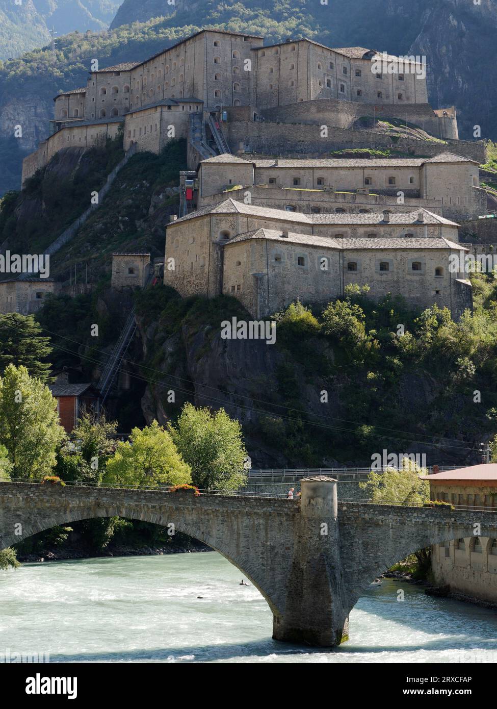 Forte di Bard (Fort of Bard) with alps behind and with bridge over the ...
