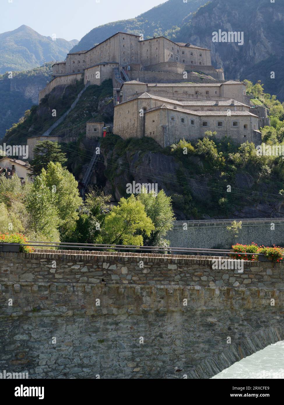 Forte di Bard (Fort of Bard) with alps behind and with bridge over the ...