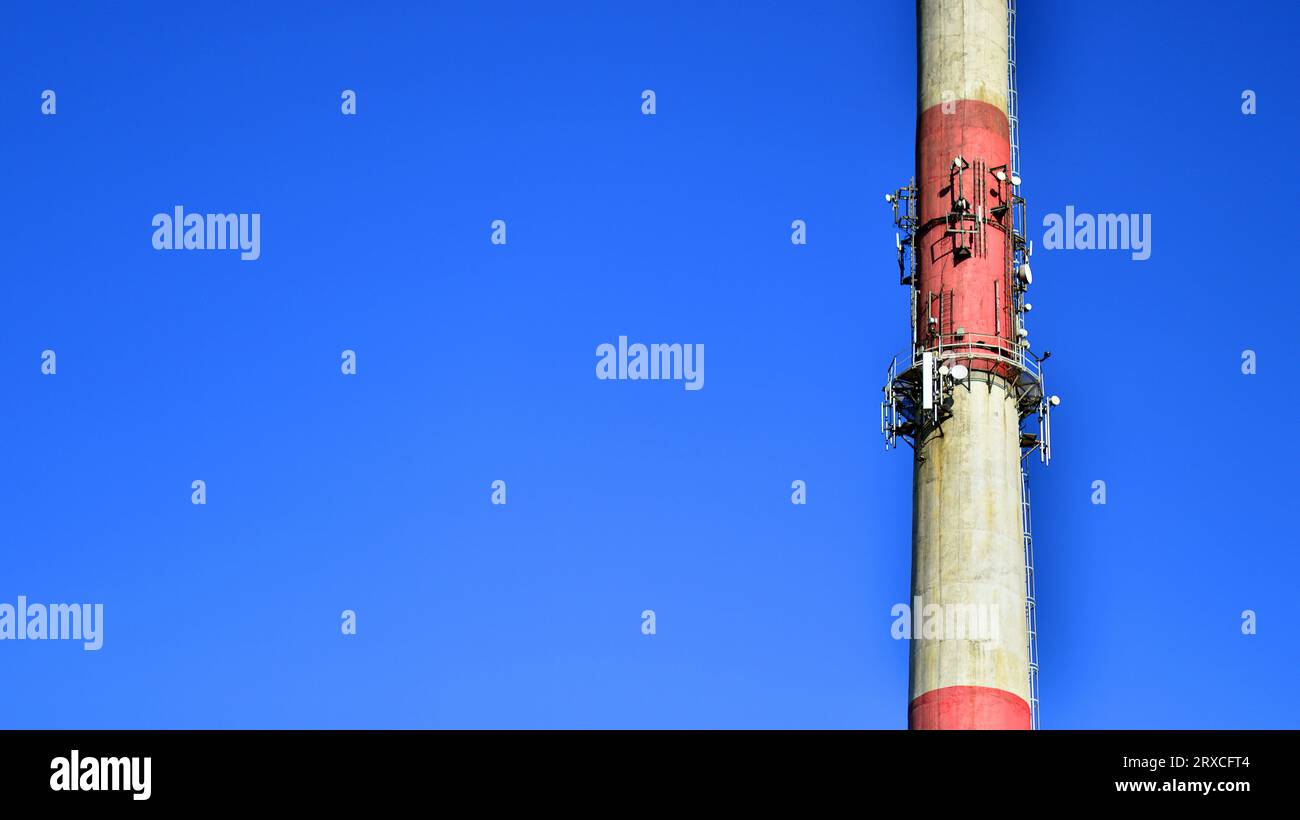 Tall industrial chimney isolated on blue sky background Stock Photo - Alamy