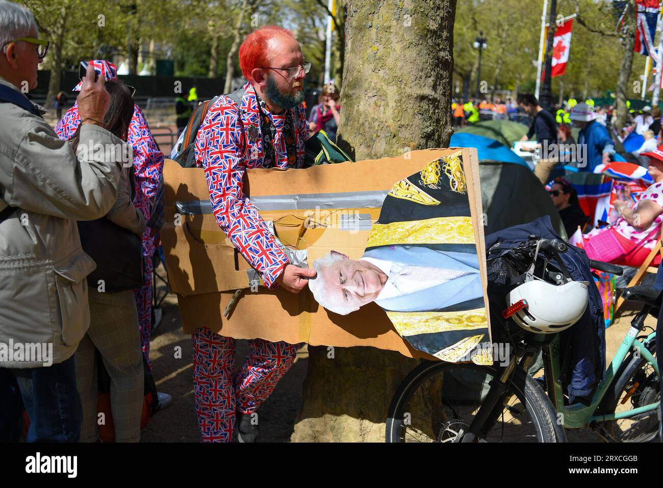A man at the Coronation of King Charles at the Mall London carries a ...