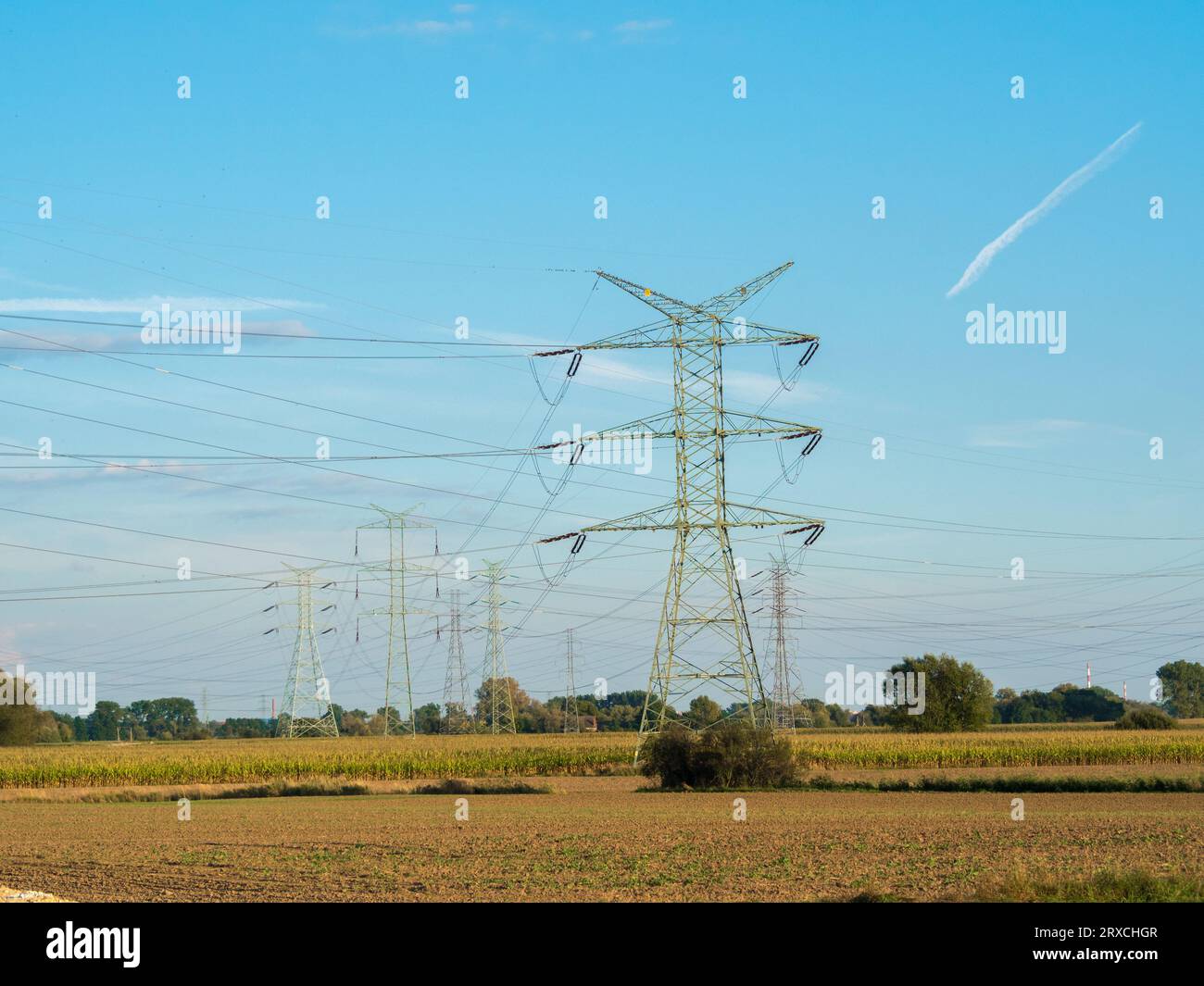 Fields with high voltage electric poles Stock Photo - Alamy