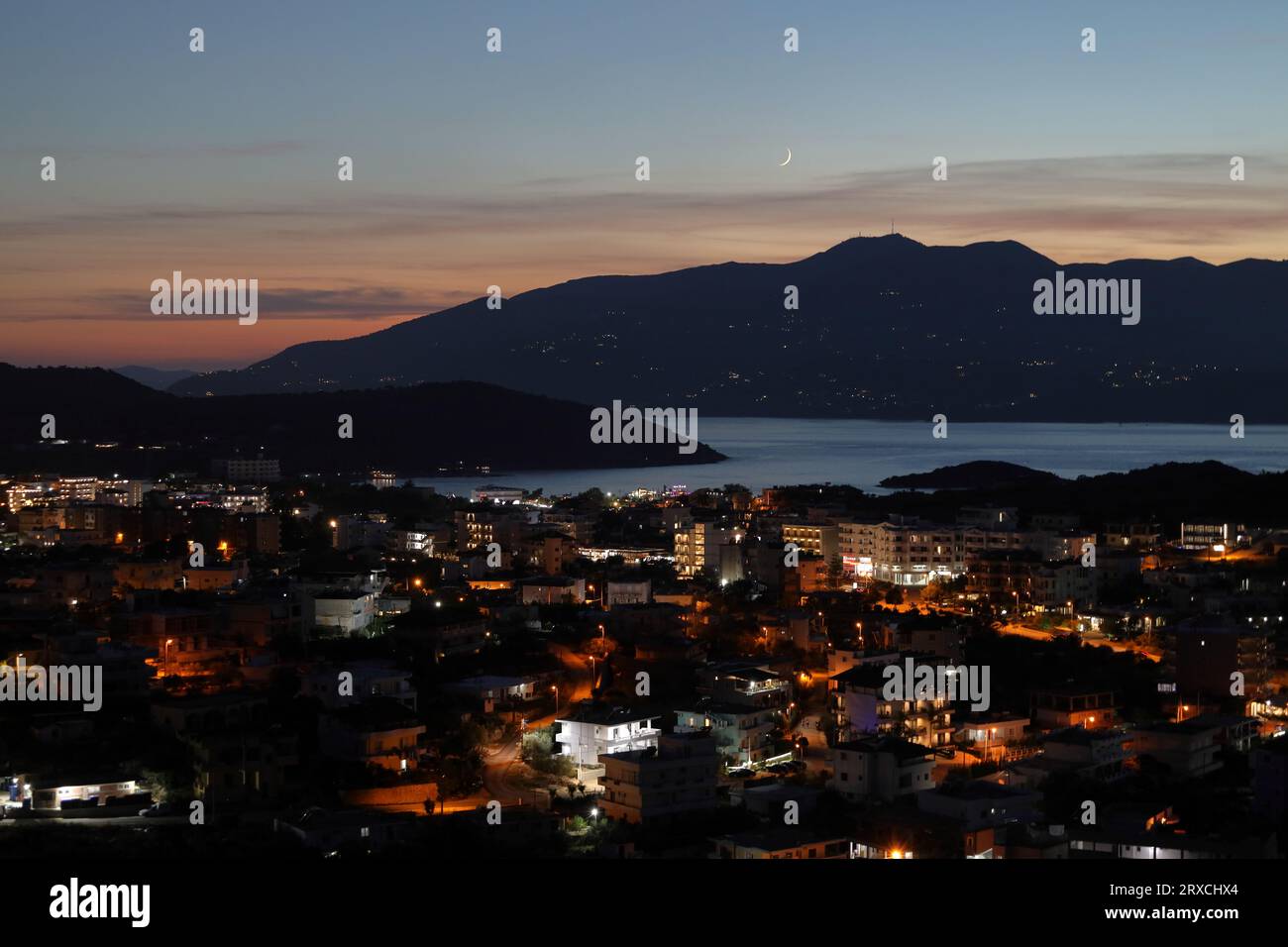 Night view of the city Ksamil in Albania on the background of Corfu ...