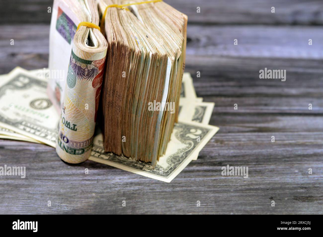 Folded Egyptian money 200 LE and pile of American money isolated on ...