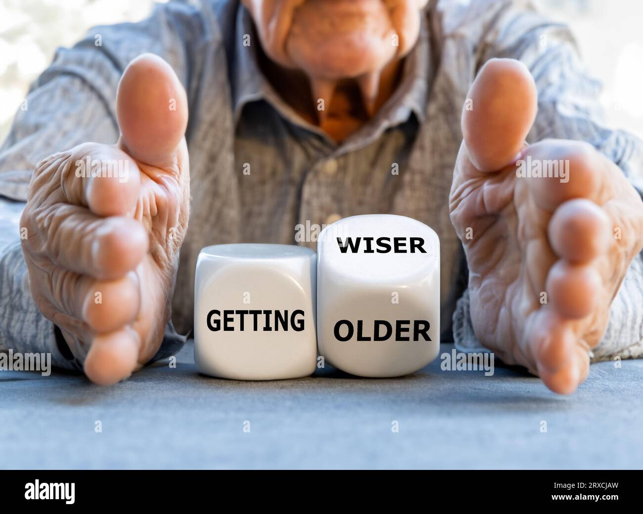 Hand turns dice and changes the expression 'getting older' to 'getting ...
