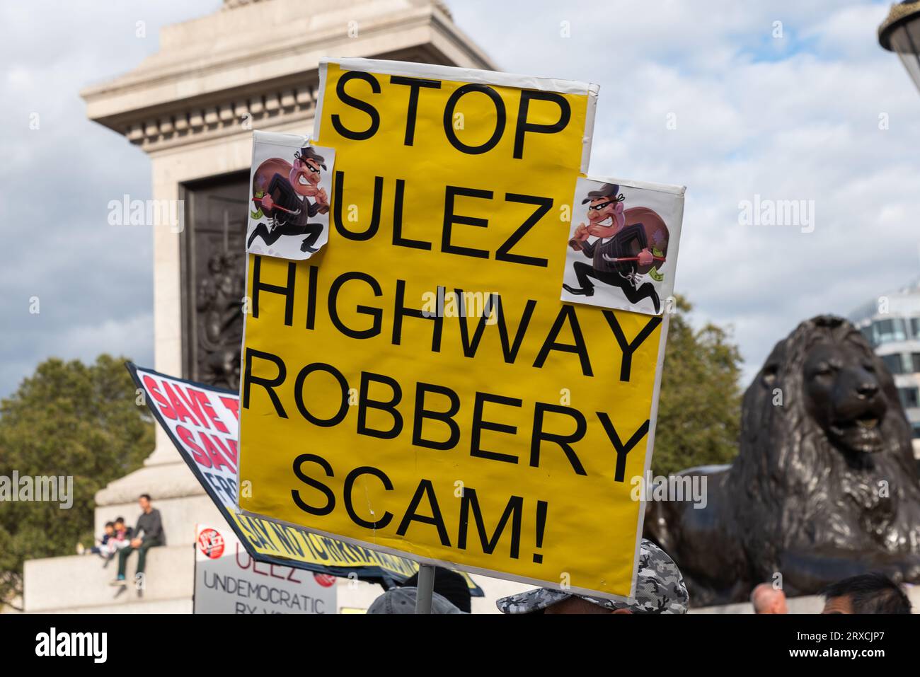 Highway robbery scam placard at a protest against the Ultra Low ...