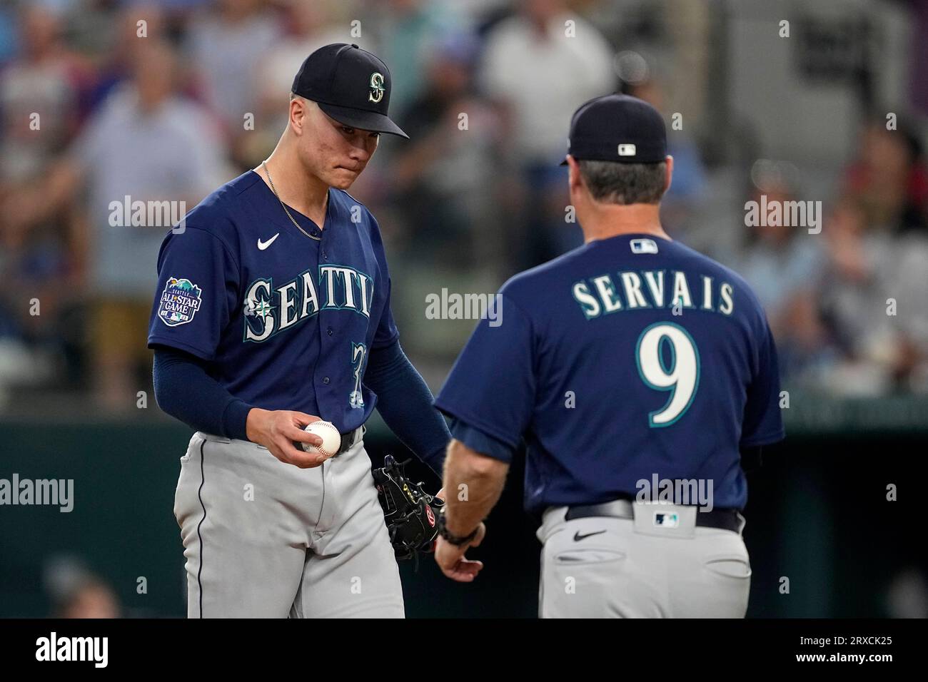 Seattle Mariners starting pitcher Bryan Woo, left, turns the ball over ...